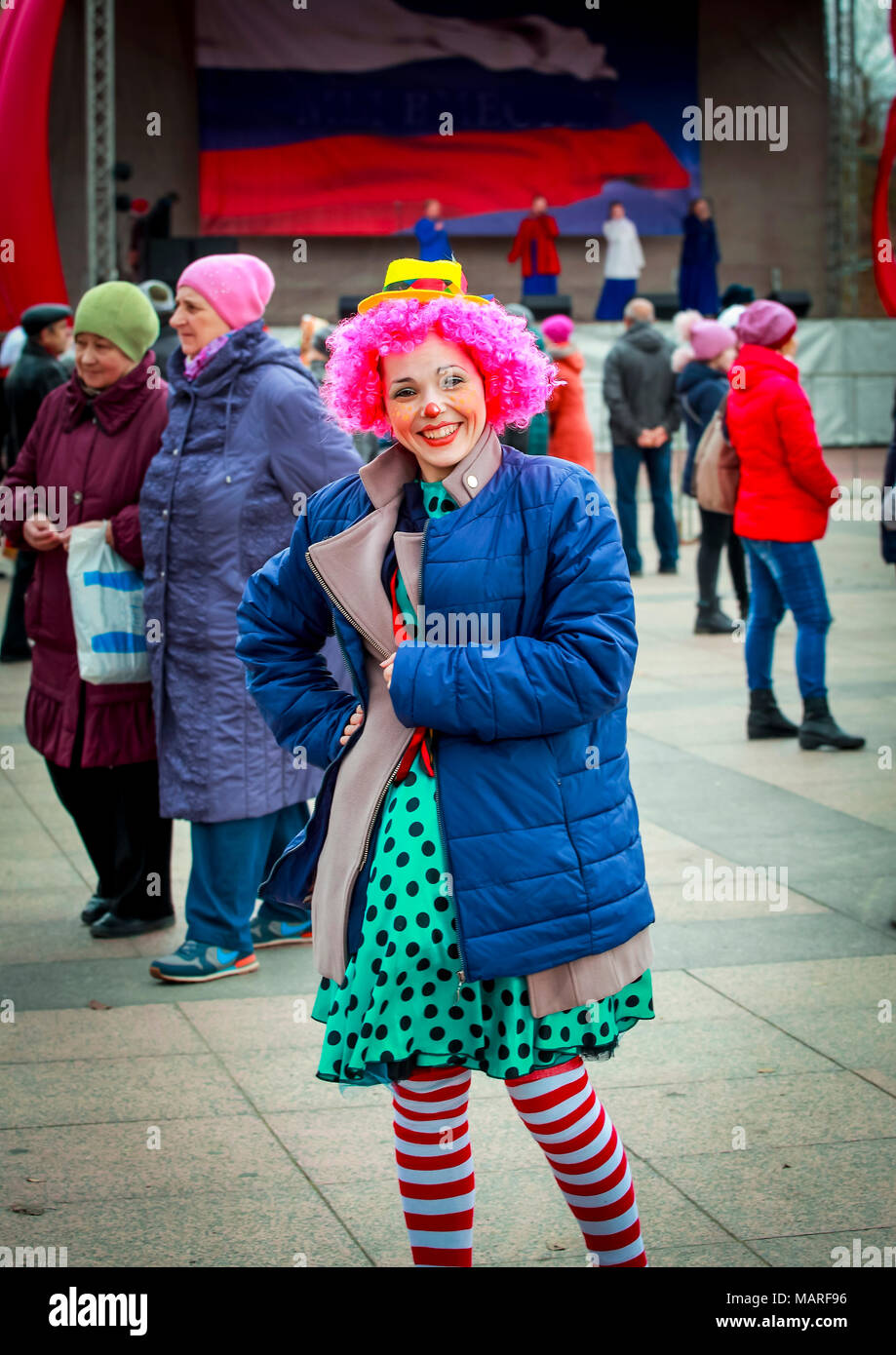 Funny playful girl clown in a colorful pink wig for the occasion Stock ...