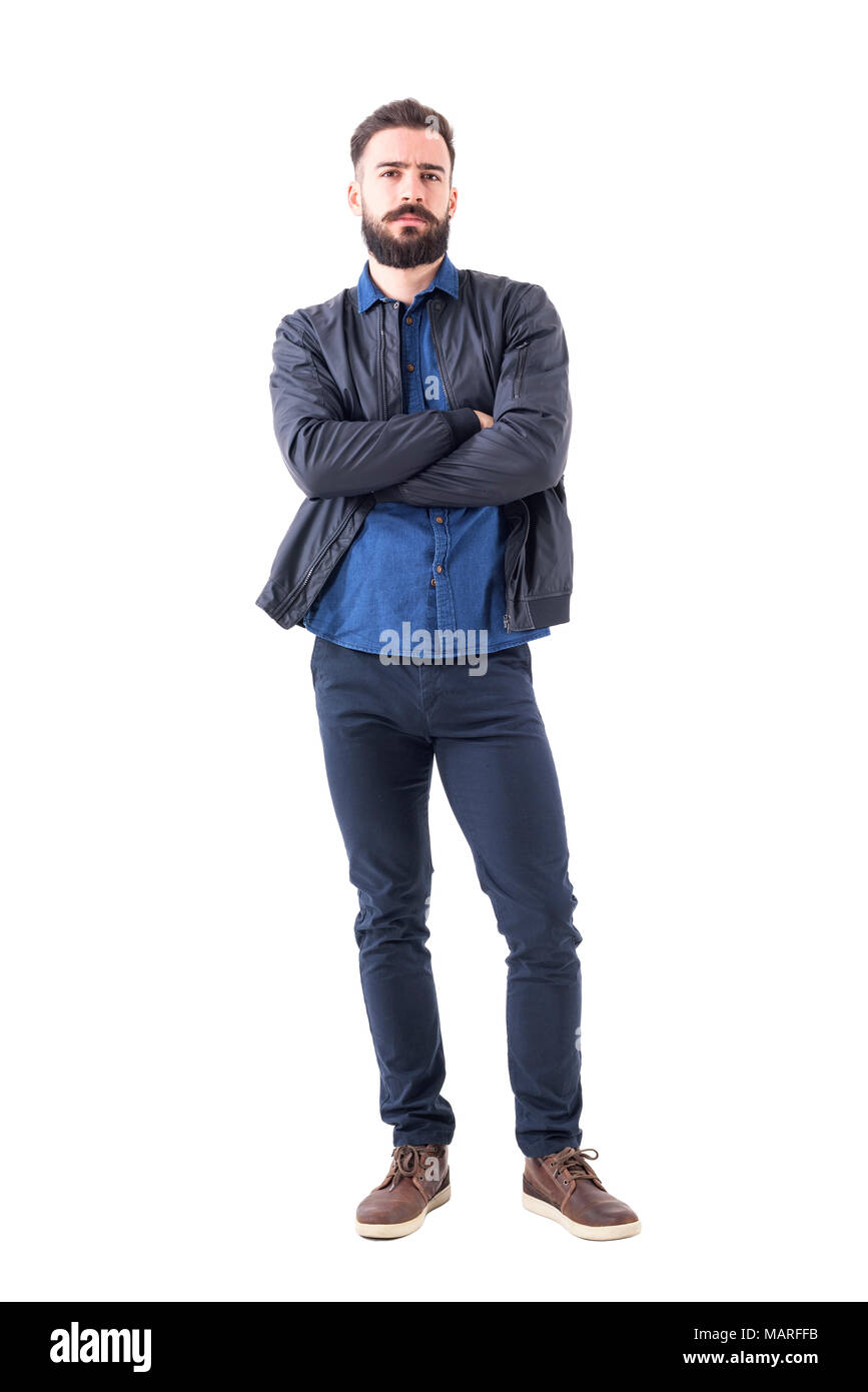 Skeptical suspicious uncertain bearded man with folded hands looking at ...