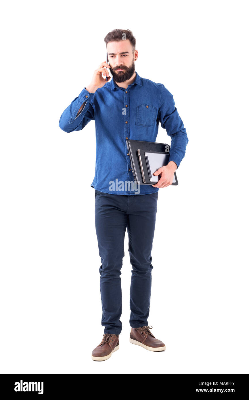 Serious upset professional business man talking on the phone carrying ...