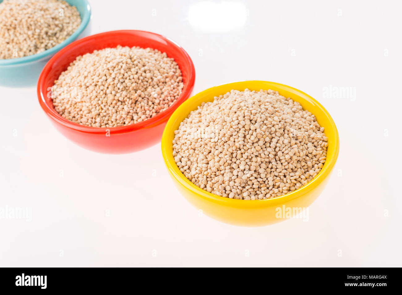 Quinoa grains in bowl isolated on white background, Chenopodium quinoa ...