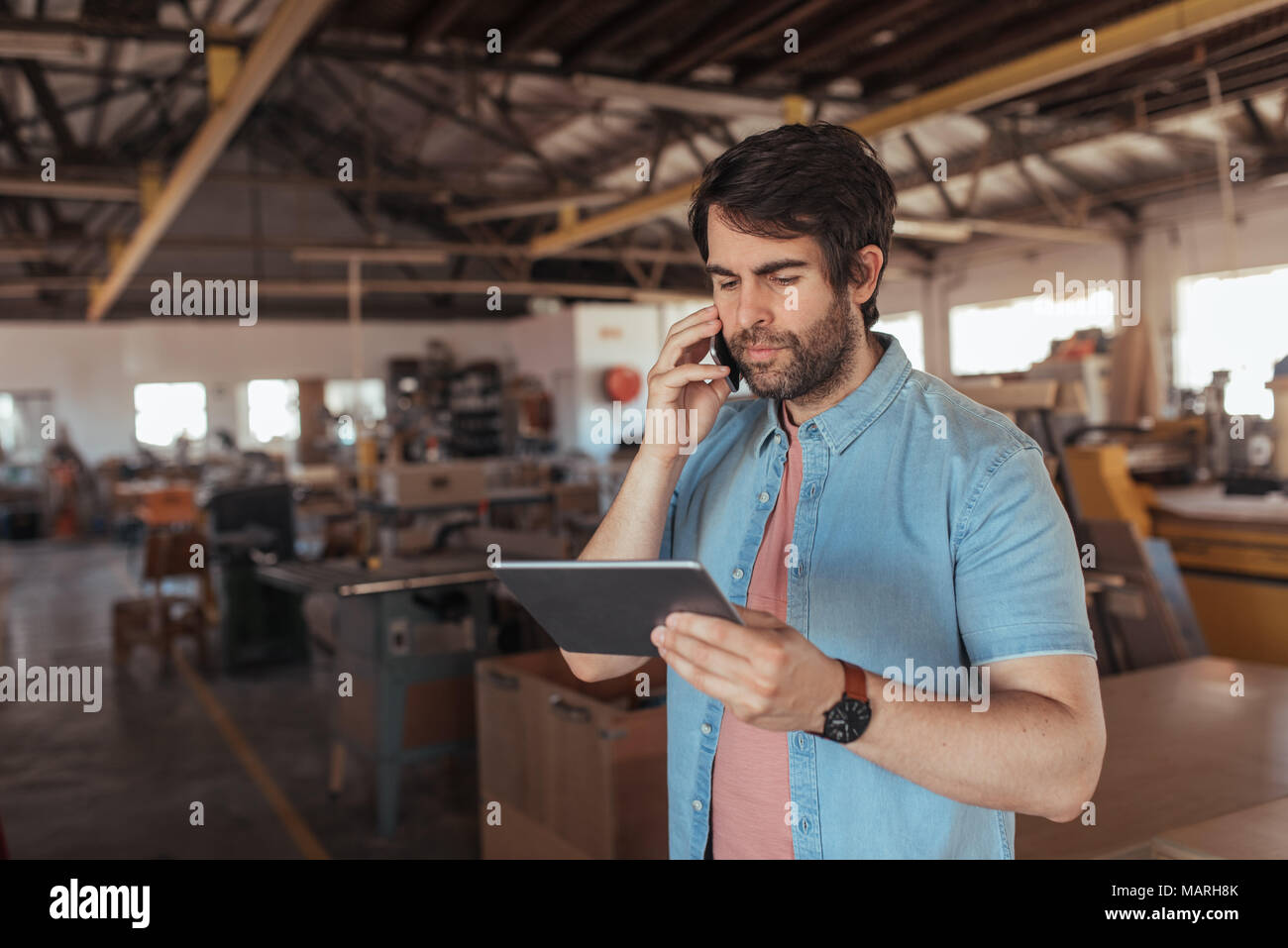 Carpenter using phone in workshop hi-res stock photography and images ...