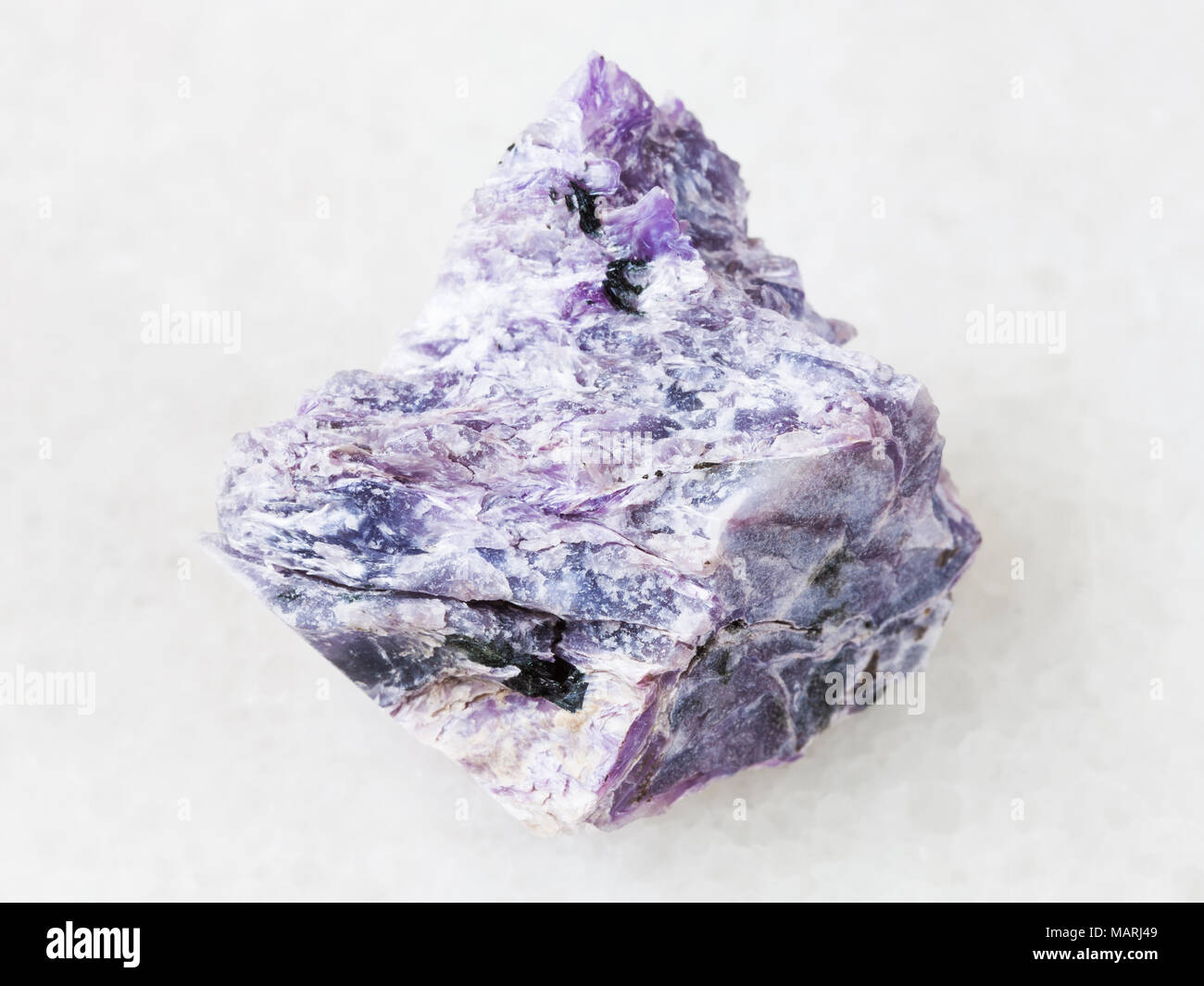 macro shooting of natural mineral rock specimen - piece of charoite ...