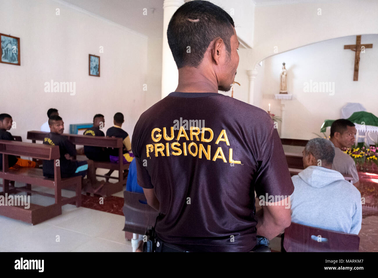 A guard looks after prisoners in the chapel at the Gleno, jail in ...