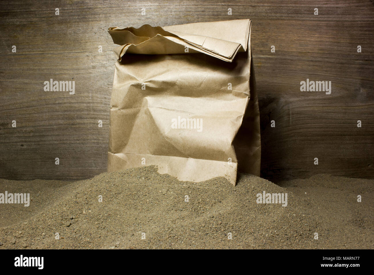 Construction sand and paper bag on wooden background Stock Photo - Alamy