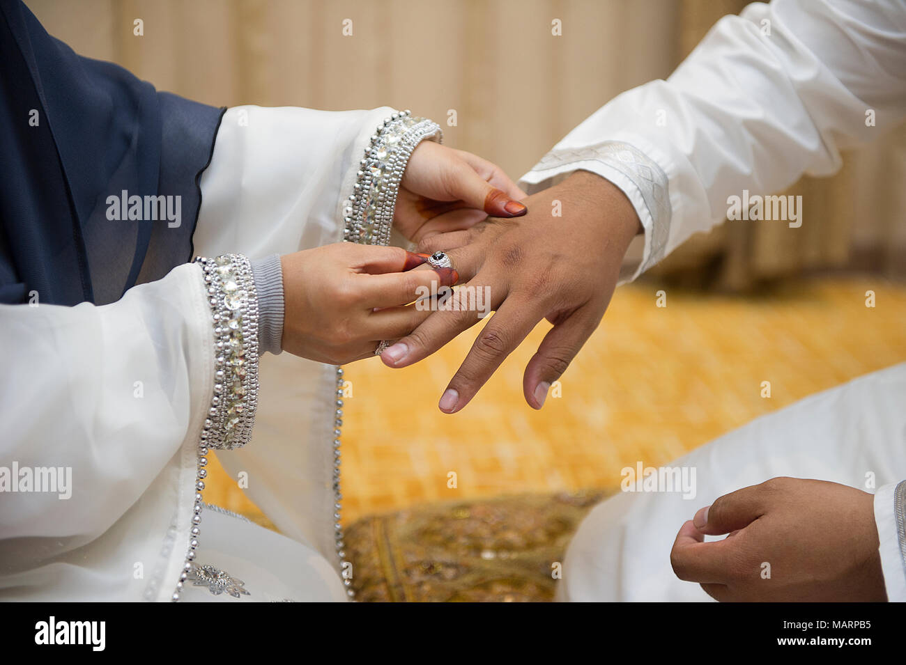 Malay wedding couple giving ring as a wedding present Stock Photo - Alamy