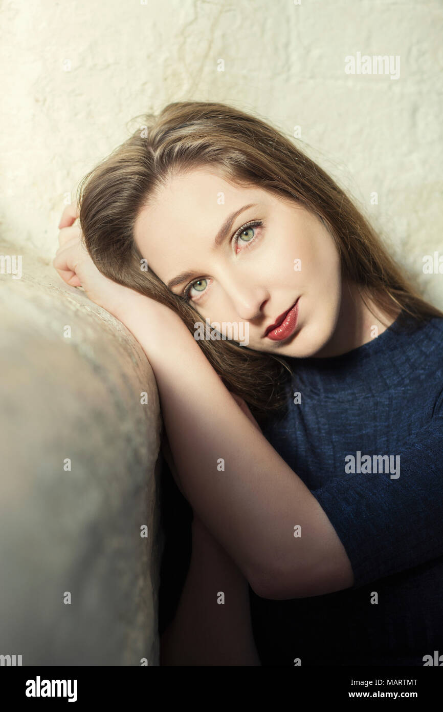 Beautiful woman leaning on a window sill Stock Photo - Alamy