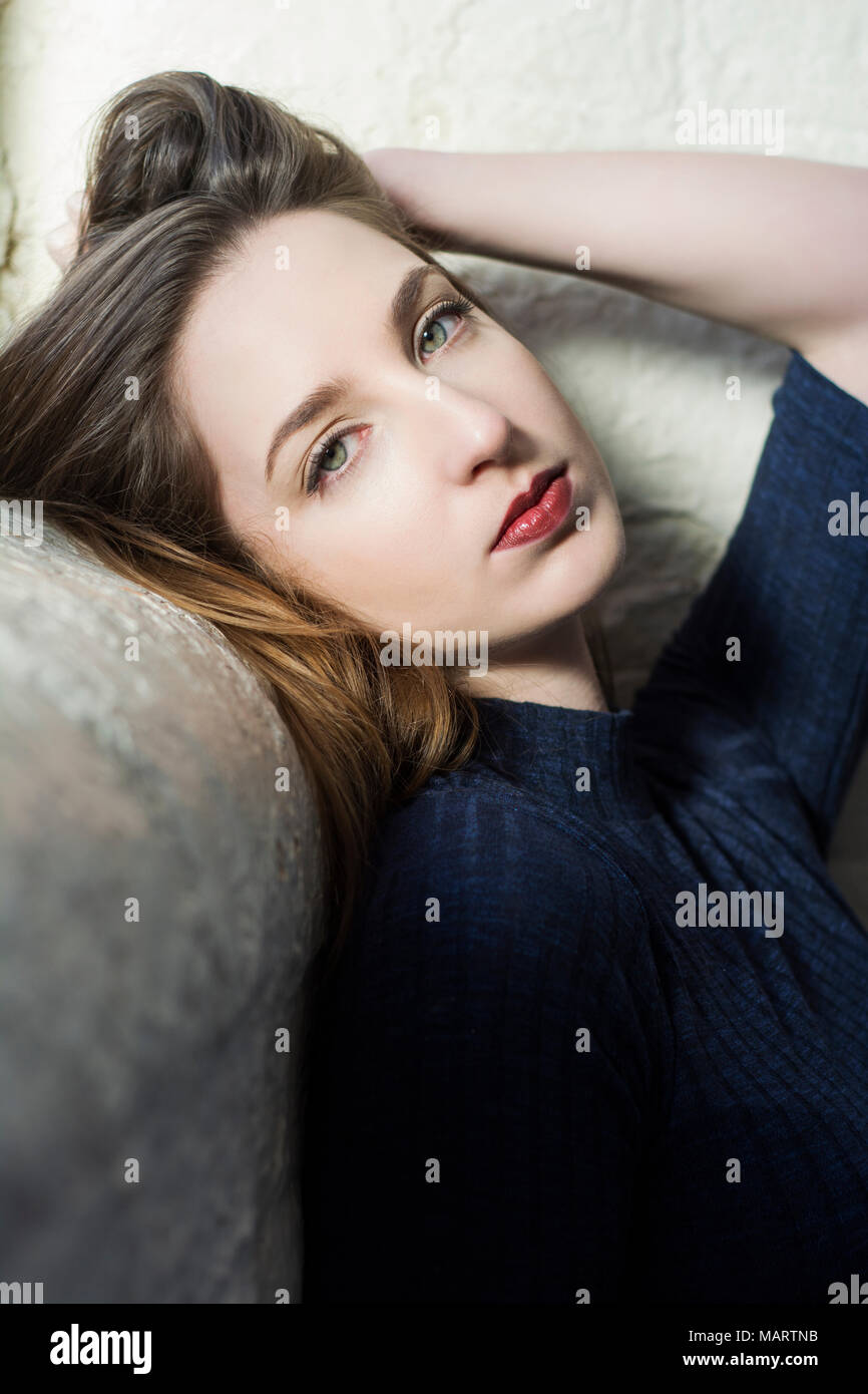 Beautiful woman leaning on a window sill Stock Photo - Alamy