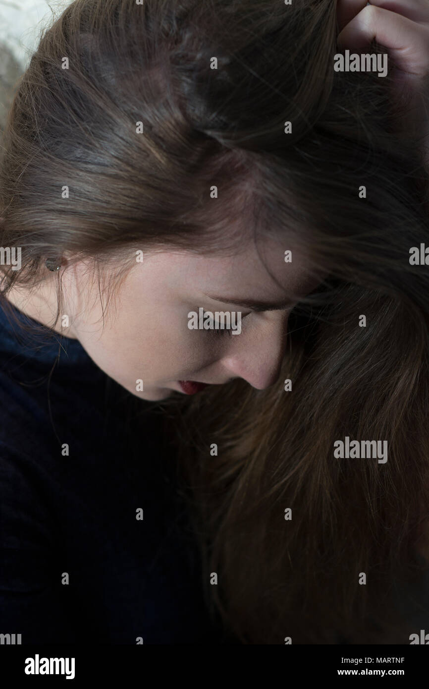 Portrait of a sad woman looking down Stock Photo - Alamy