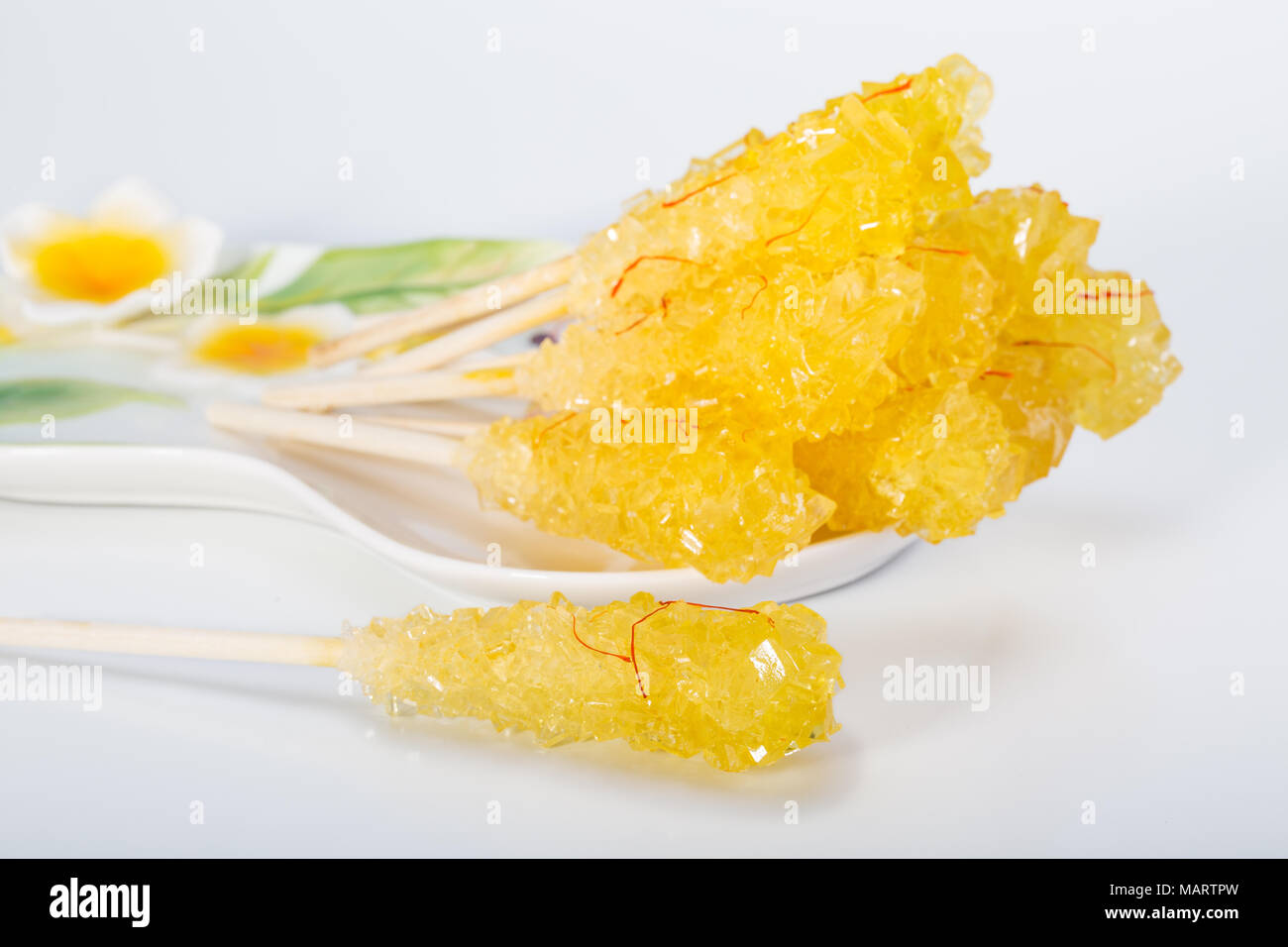 Close Up Of Saffron Rock Candy Sugar Crystal in A White Plate Isolated ...