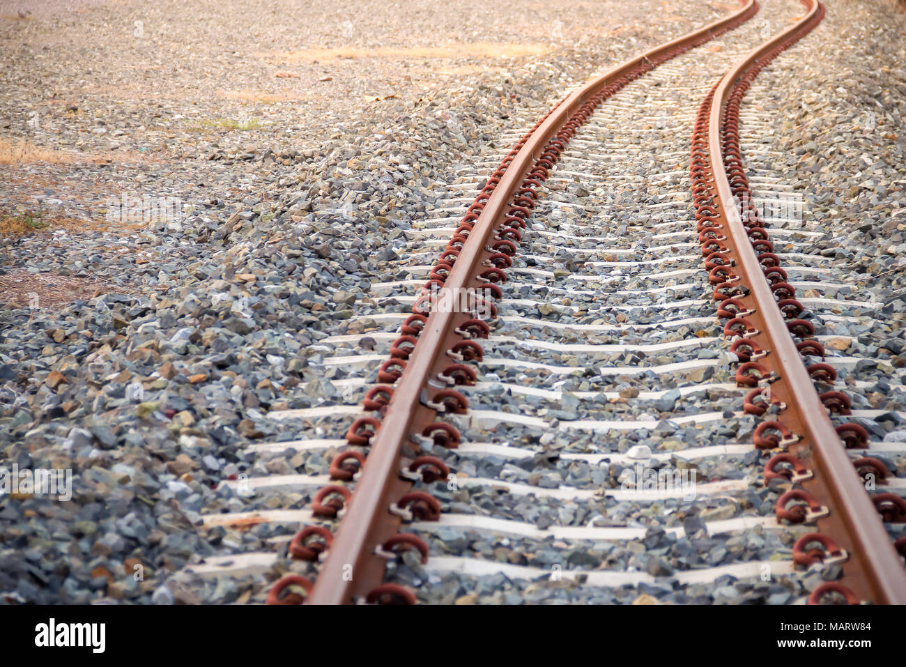 Single Red Curve Railway Track on The Ground Stock Photo - Alamy