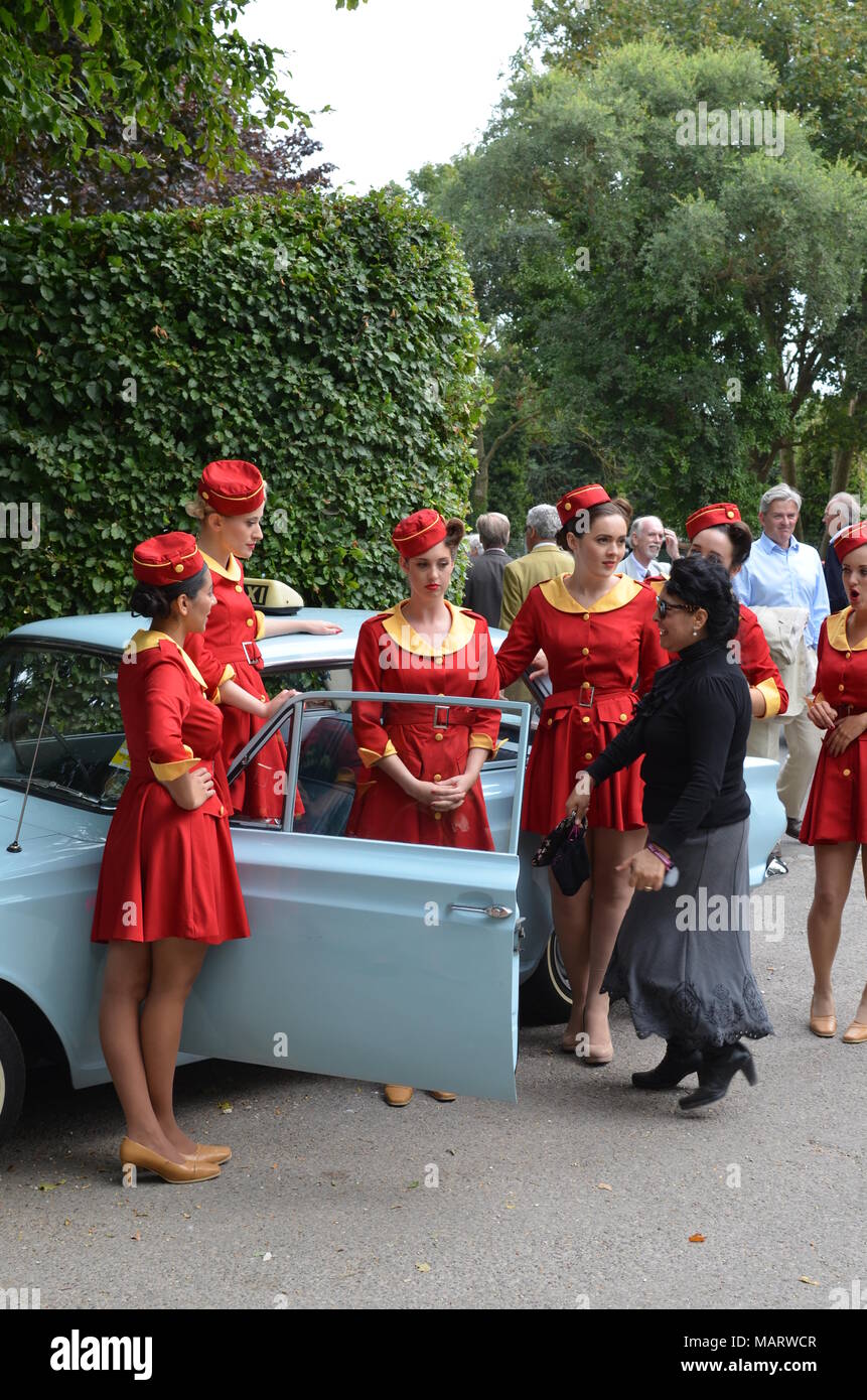 Girls in taxi cab uniforms taking part in the 2014 Goodwood Revival ...