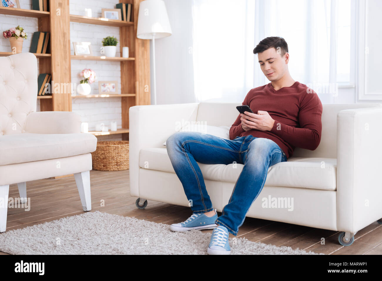 Pensive smart man reading message Stock Photo - Alamy