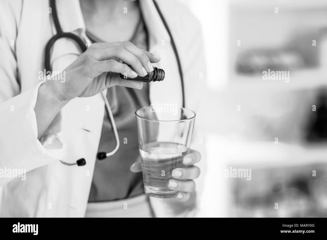 Closeup on medical doctor woman calmative into glass Stock Photo - Alamy
