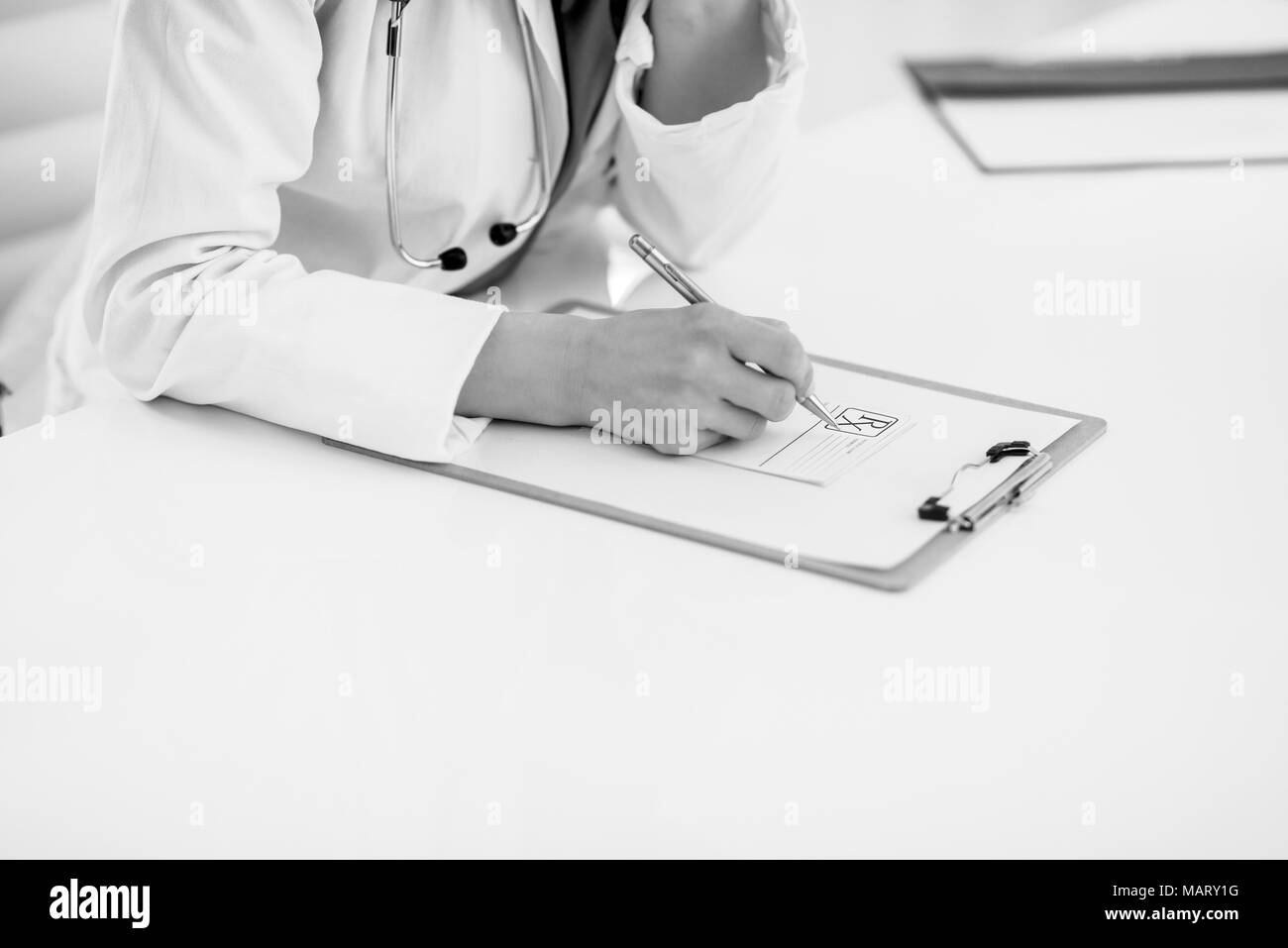 Doctor writing in prescription Black and White Stock Photos & Images ...