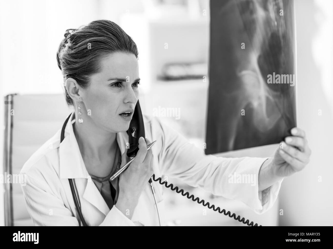Medical doctor woman looking on fluorography and talking phone Stock ...