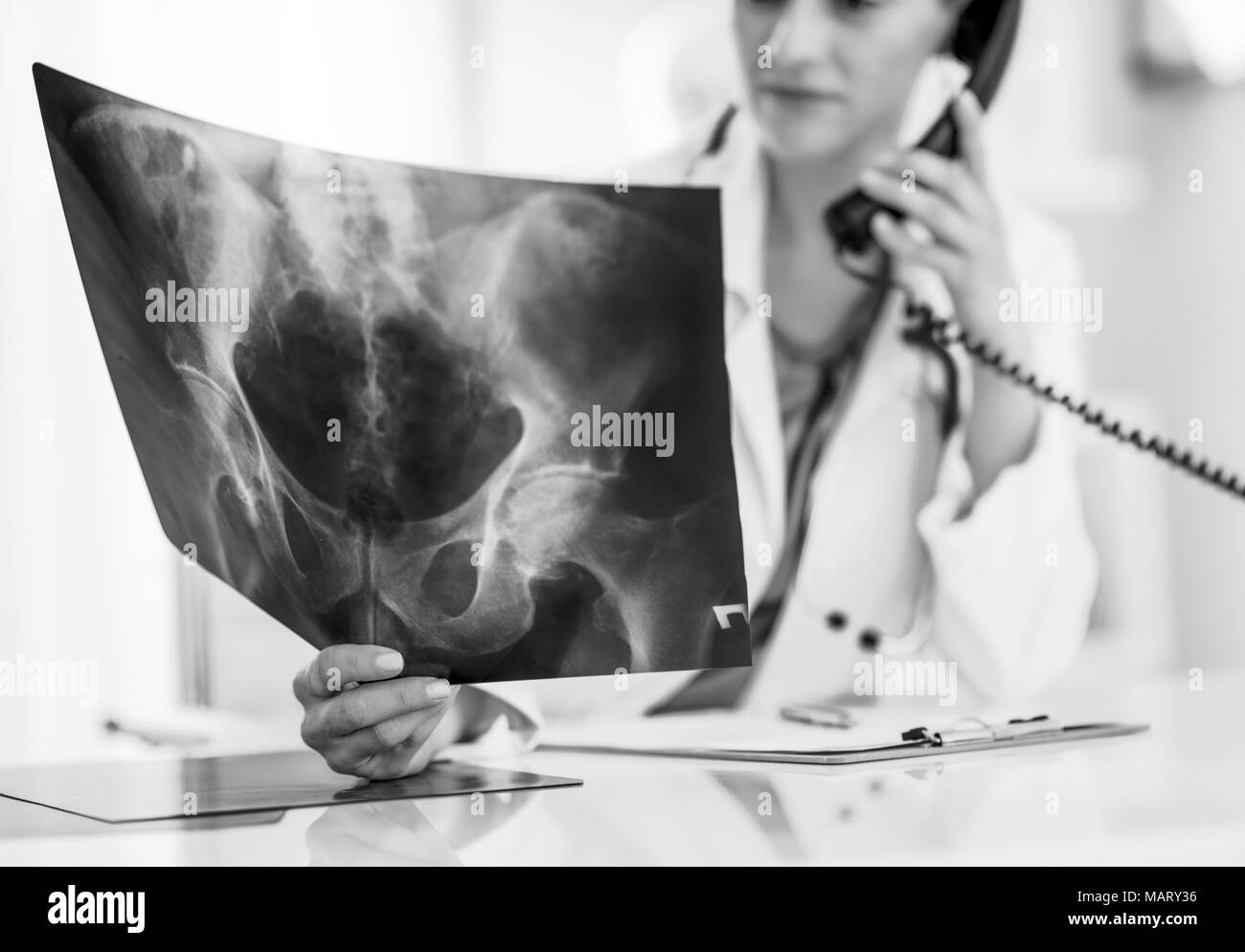 Closeup on medical doctor woman looking on fluorography and talking ...