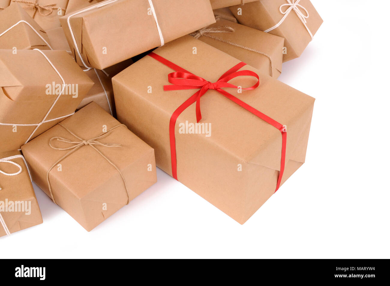 Group of parcels, one with red ribbon Stock Photo - Alamy