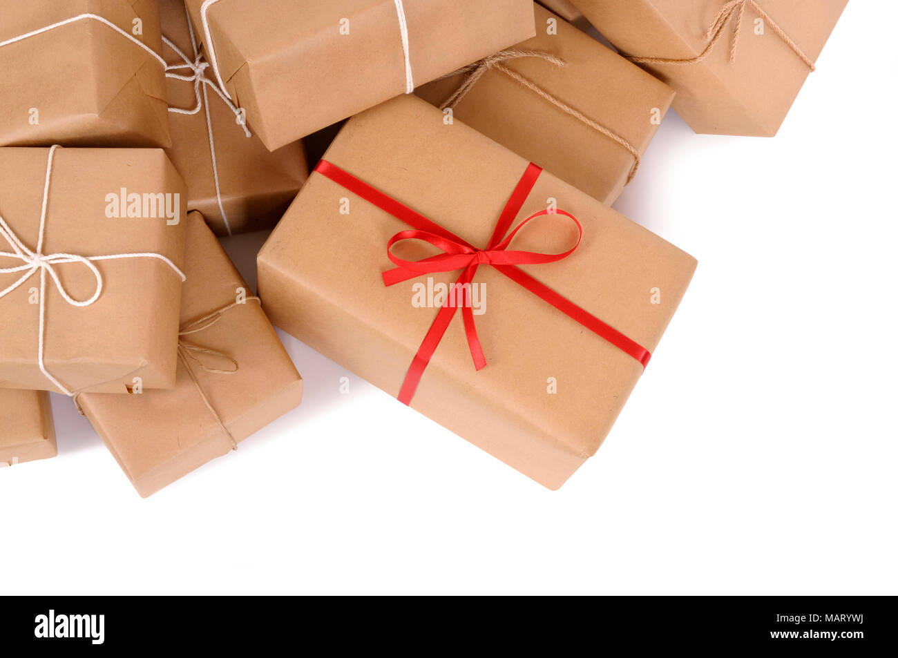 Group of parcels, one with red ribbon Stock Photo - Alamy