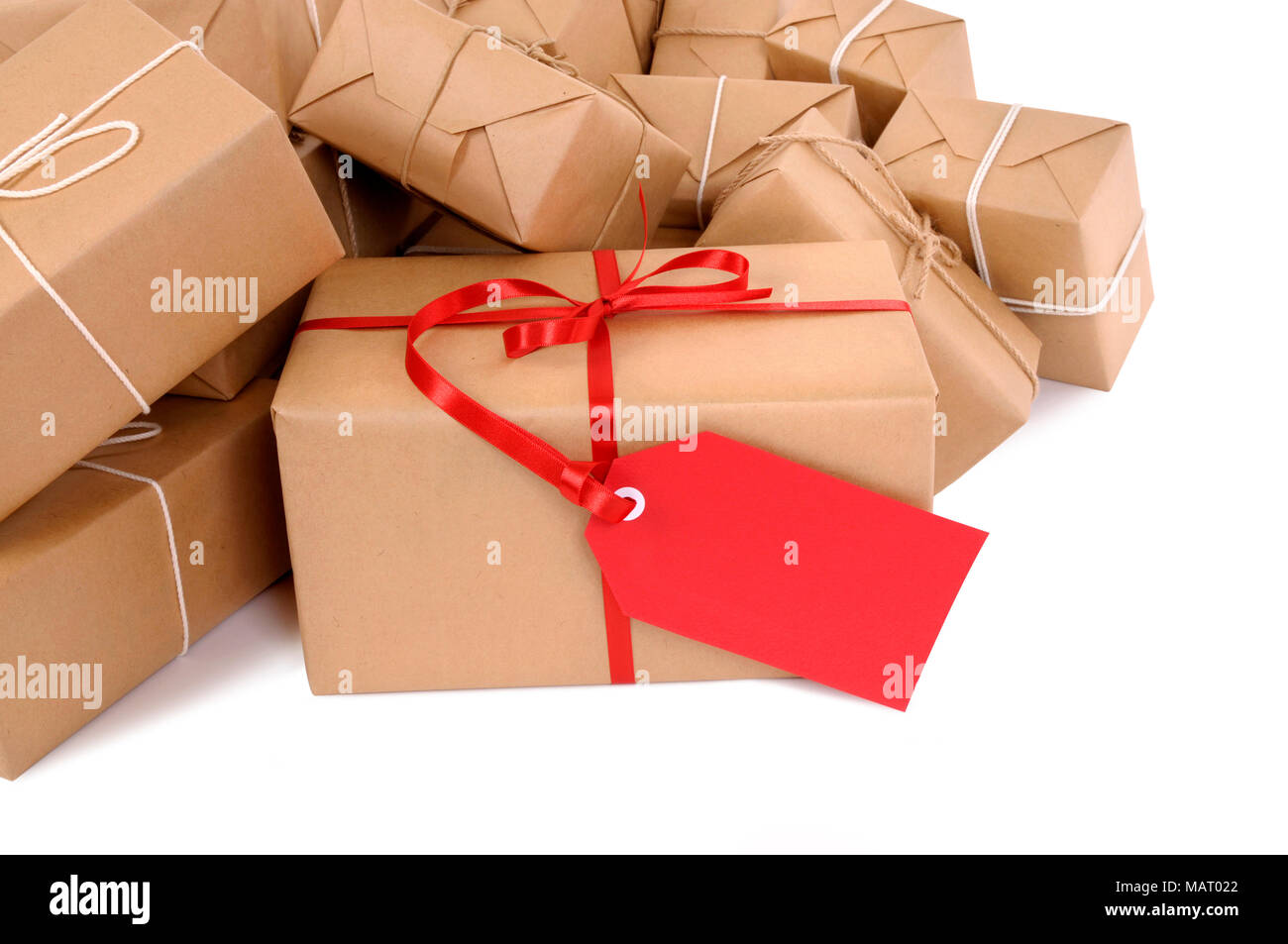 Group of parcels, red gift tag Stock Photo - Alamy