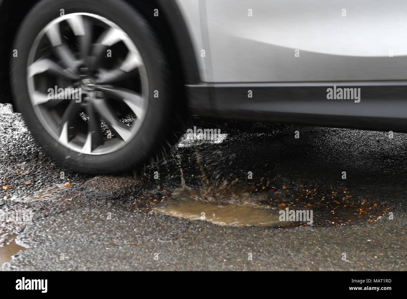 Car passes potholes in hi-res stock photography and images - Alamy