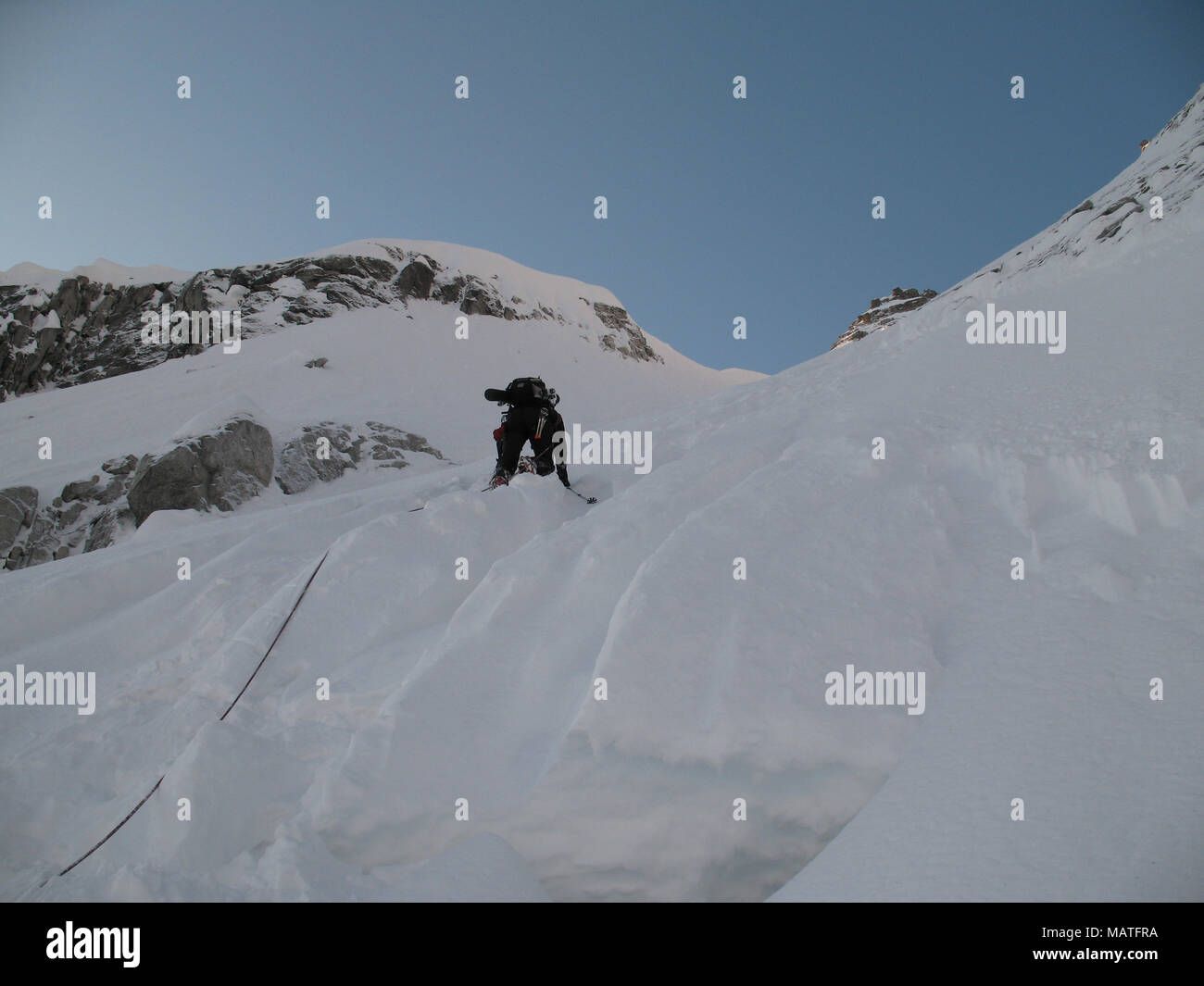male mountain climber and extreme skier crosses the bergschrund of a ...