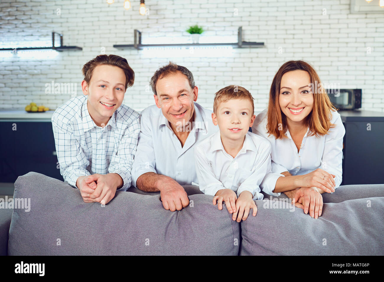 Happy family smiling in room Stock Photo - Alamy