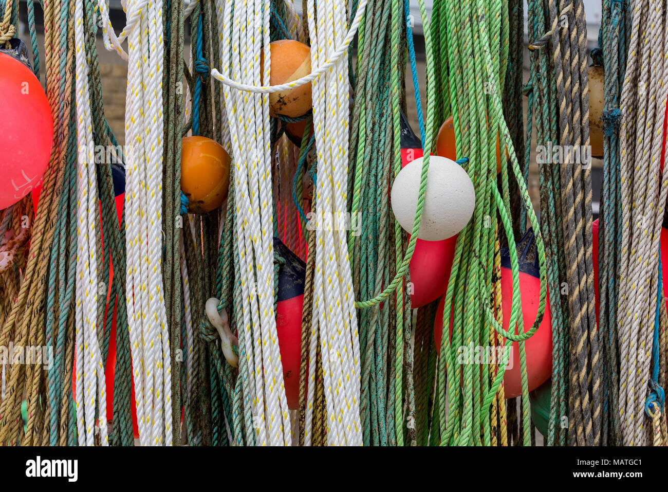 A collection of old plastic colourful fishing floats, ropes and wires ...