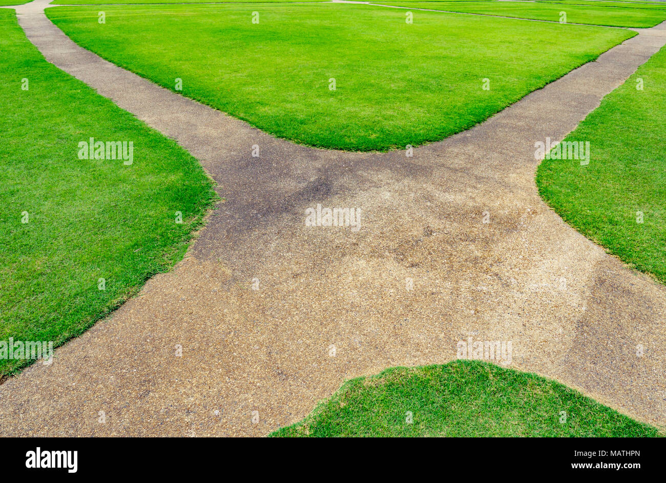 Pathway on the green lawn texture background. Intersection walkway ...