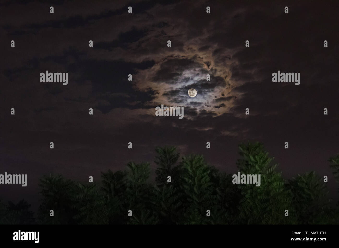 moon between clouds Stock Photo - Alamy