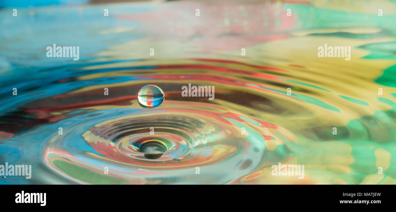 colorful water drop splash in a body of water Stock Photo - Alamy