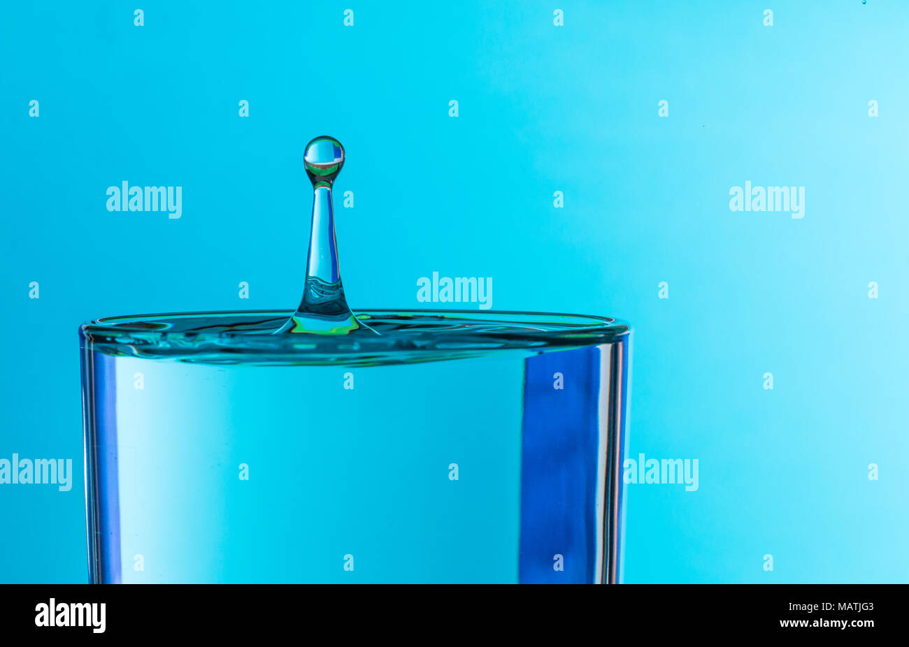 water drop splash in a glass of drinking water Stock Photo - Alamy