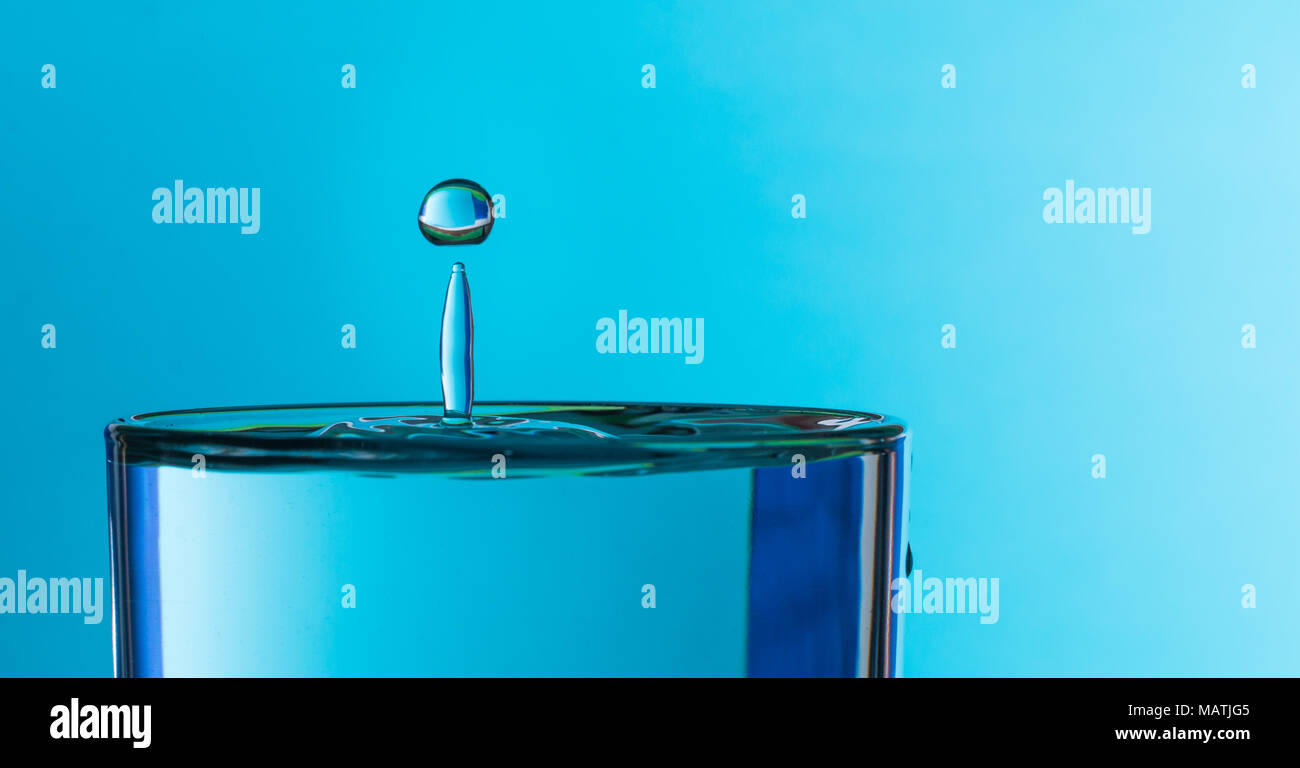 water drop splash in a glass of drinking water Stock Photo - Alamy