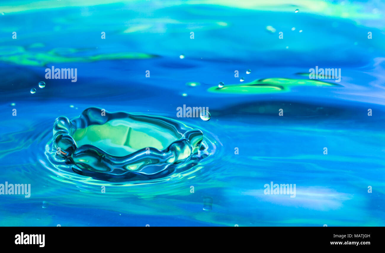 Blue water drop splash in a pond of clear water Stock Photo - Alamy