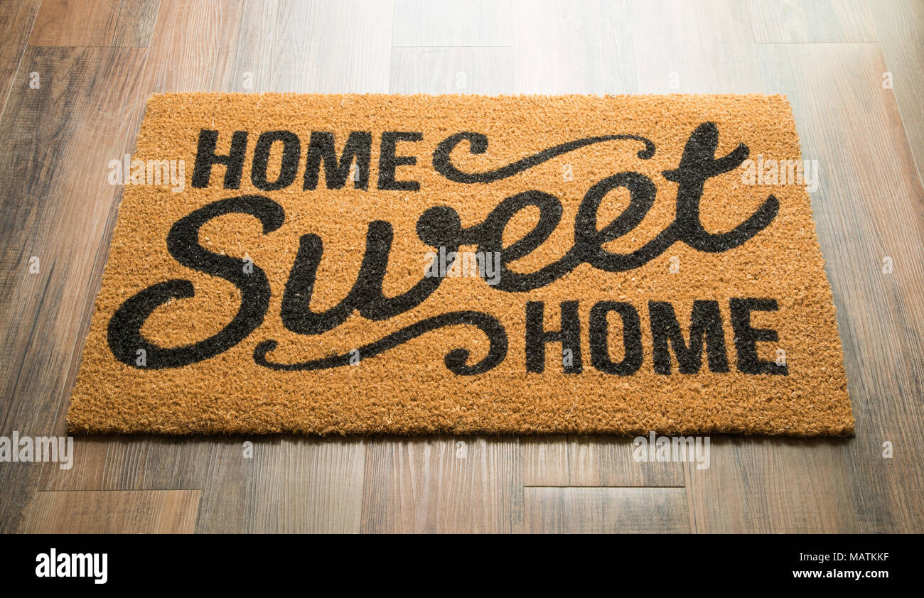 Home Sweet Home Welcome Mat On Wood Floor Stock Photo - Alamy