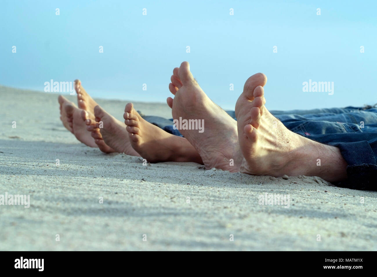 feet four people lying Stock Photo - Alamy