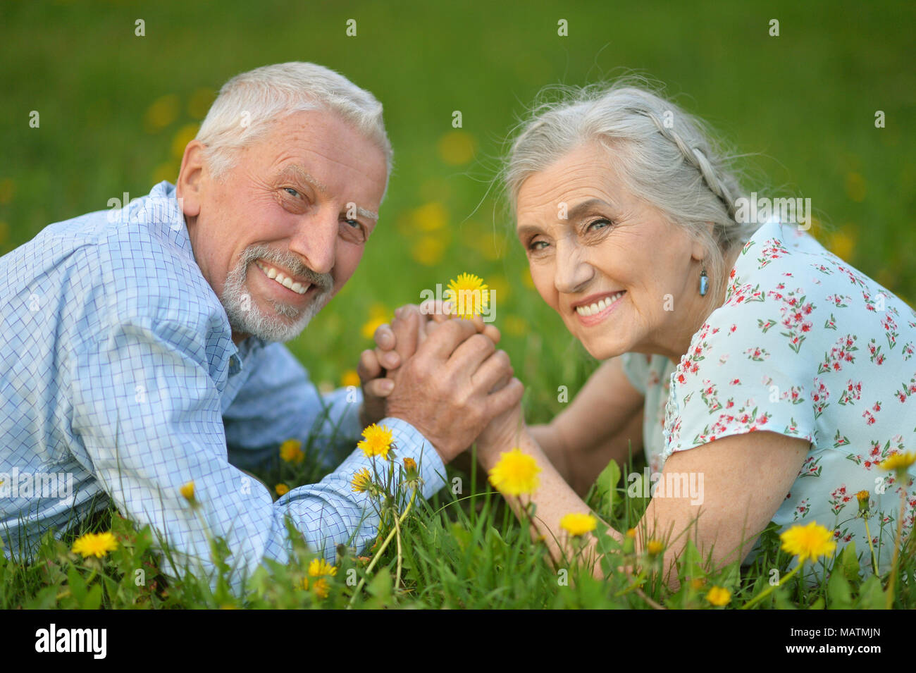 Woman lying grass dandelions hi-res stock photography and images - Alamy
