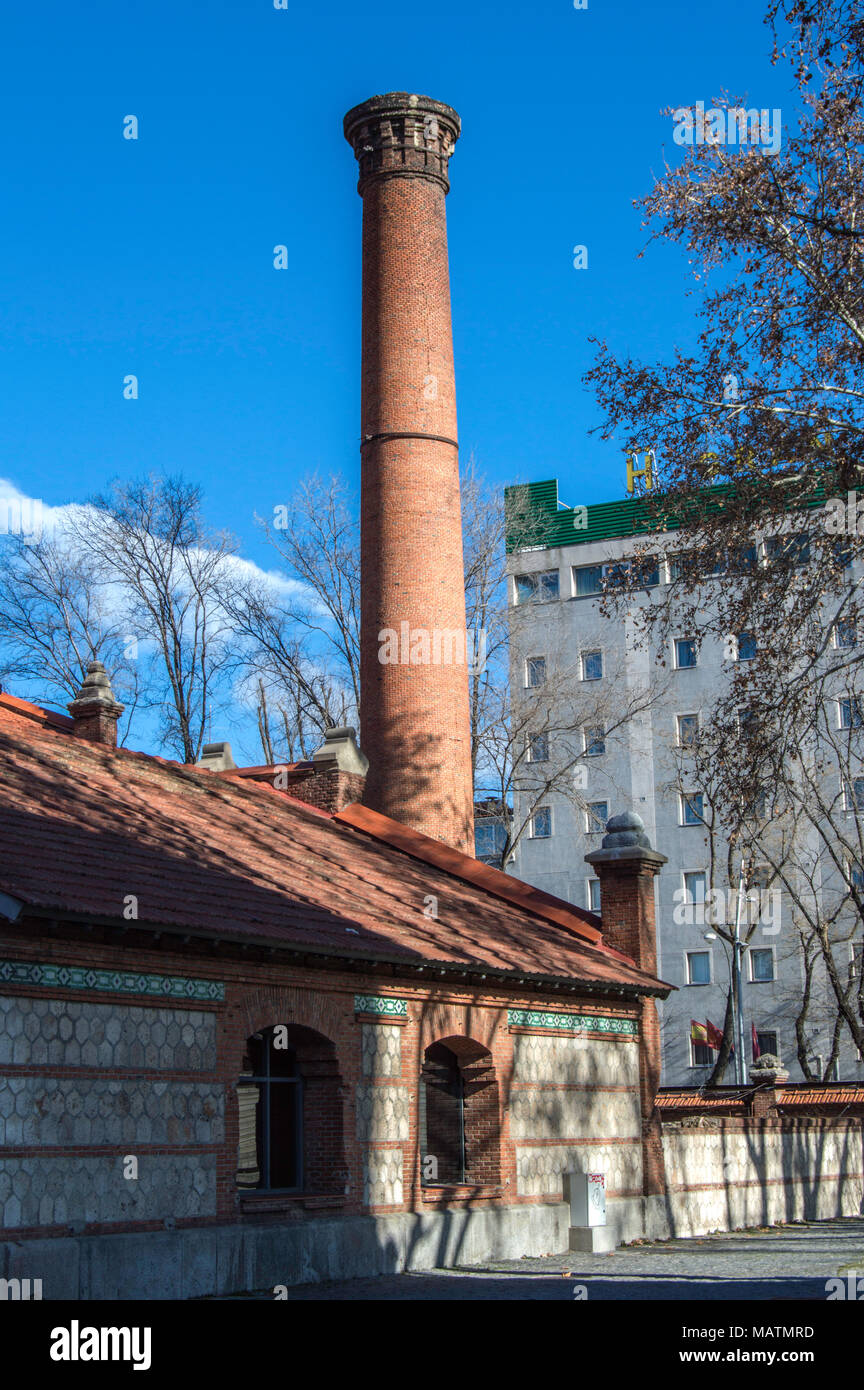 industrial smokestack next to a brick building in a place of Madrid ...