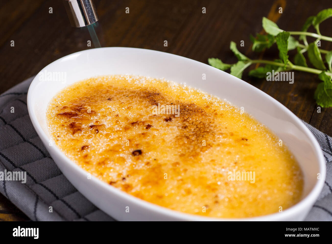 Caramelizing Creme Brulee Using a Torch Stock Photo - Alamy