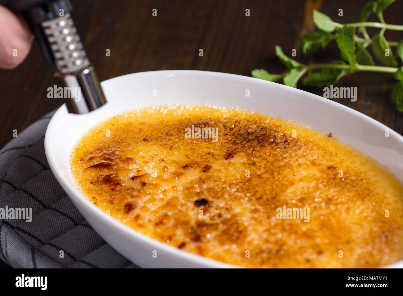 Caramelizing Creme Brulee Using a Torch Stock Photo - Alamy
