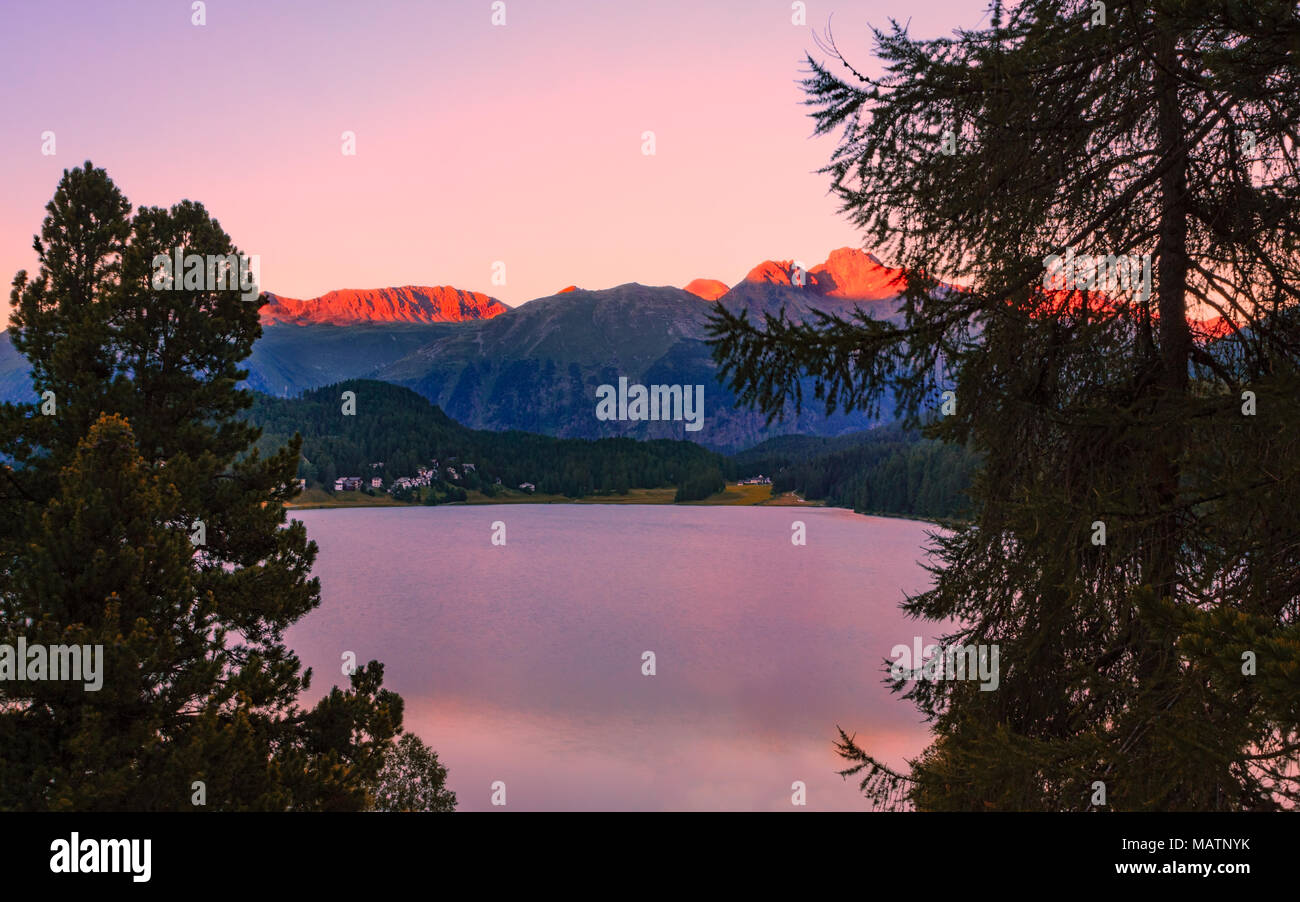 Last light of the day shines on the Alps behind the lake of St. Moritz ...