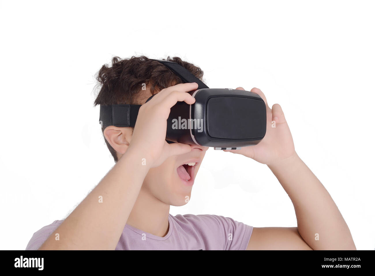 Joyful teen boy using VR goggles. Virtual reality concept. Isolated on ...