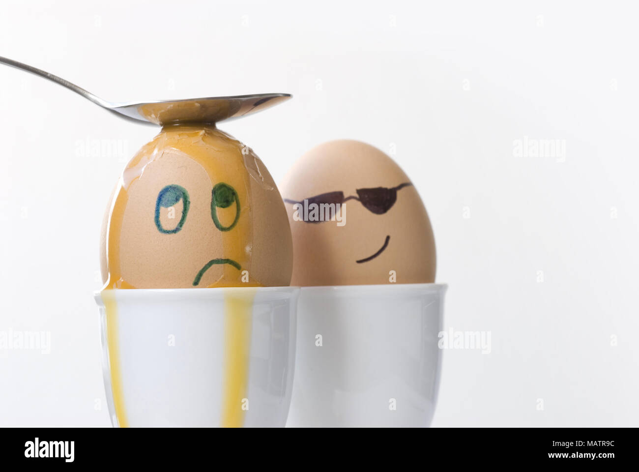 Sad egg finally gets his dues from gangster egg Stock Photo - Alamy