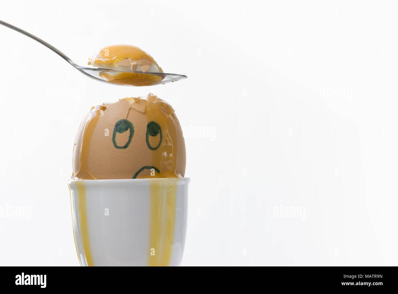 An unhappy, confused and dazed boiled egg. Copy space on right Stock ...