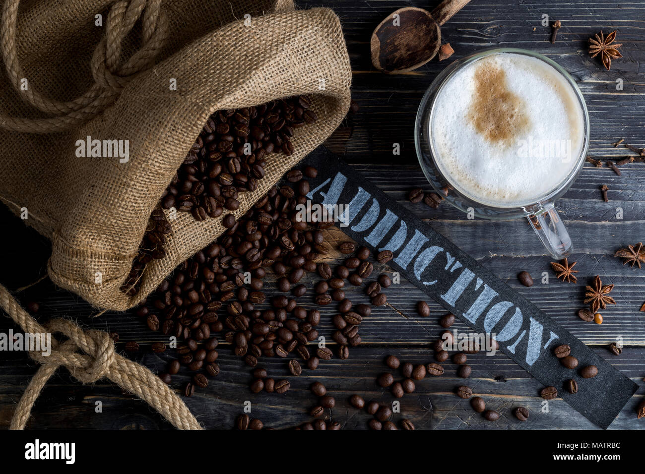 Coffee addiction with wooden background, jute bag, spices and coffee ...