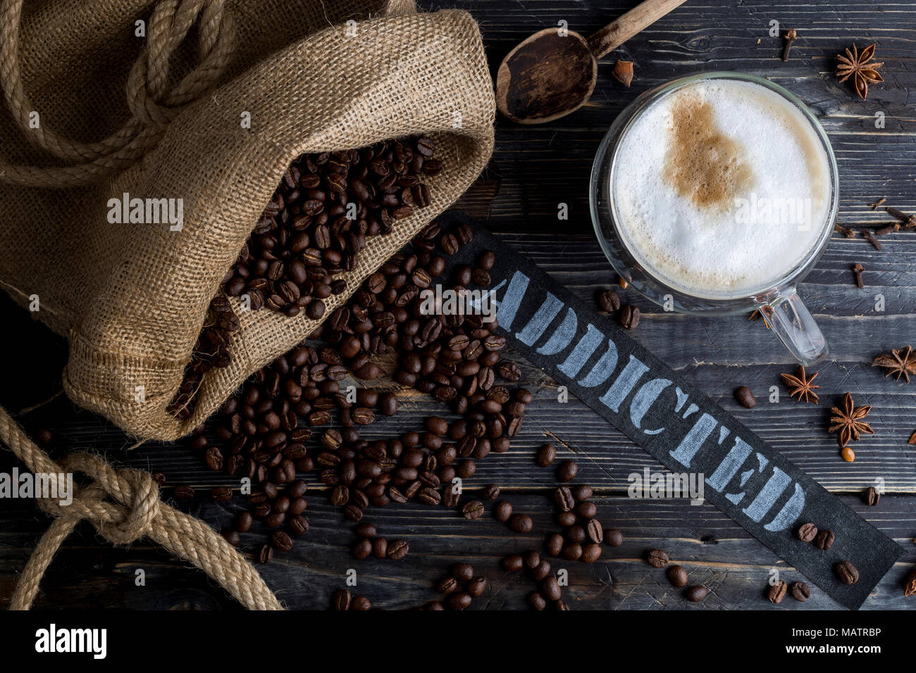 Coffee addiction with wooden background, jute bag, spices and coffee ...