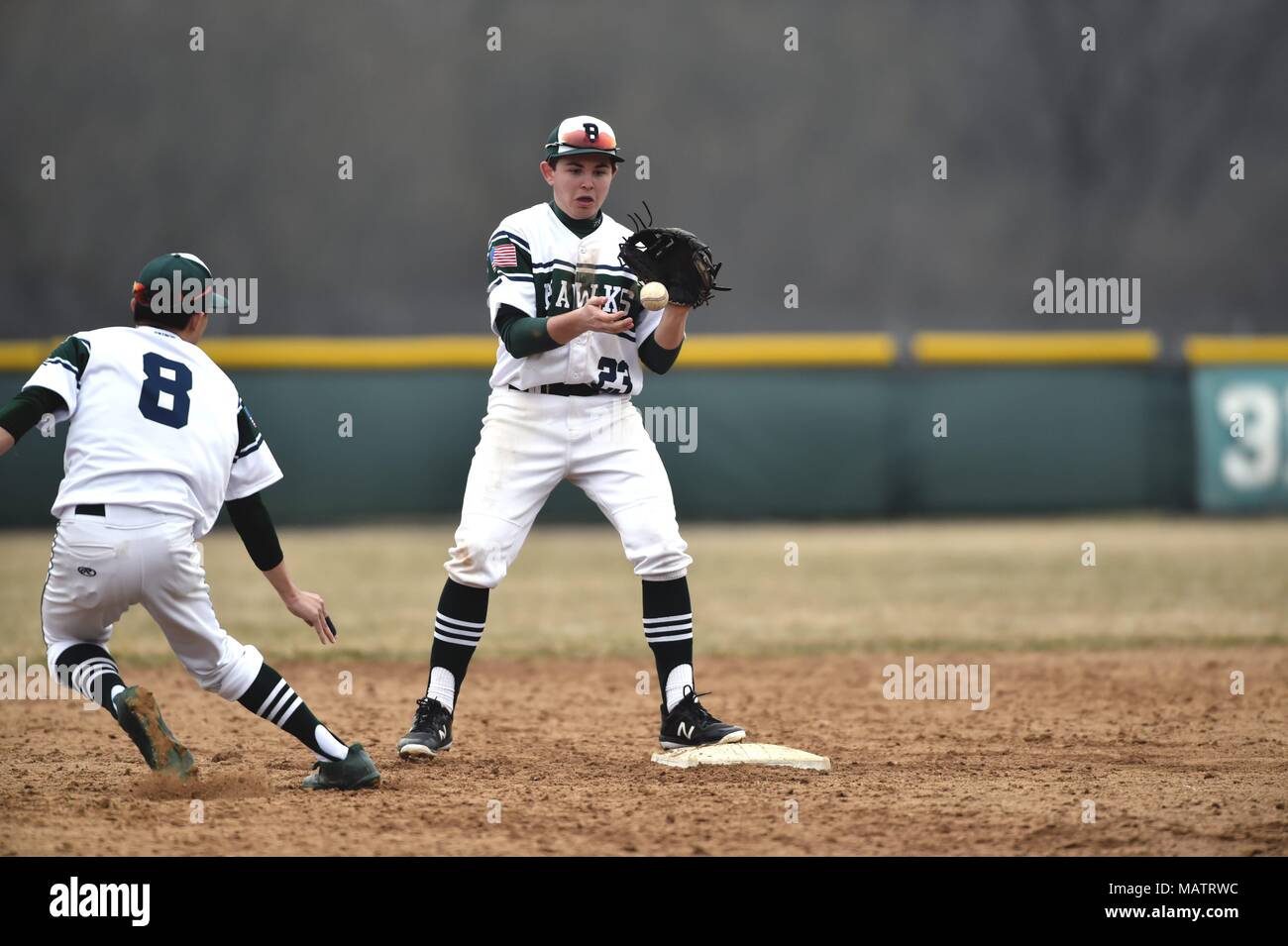 Second baseman taking a flip to retire a runner at second base as the ...
