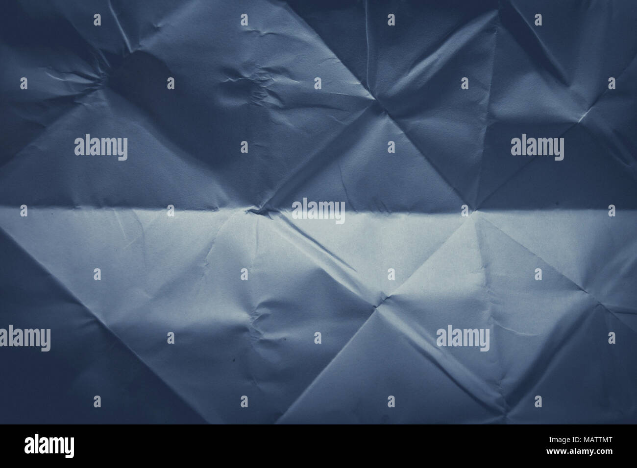 Photograph of a folded paper background or texture Stock Photo - Alamy