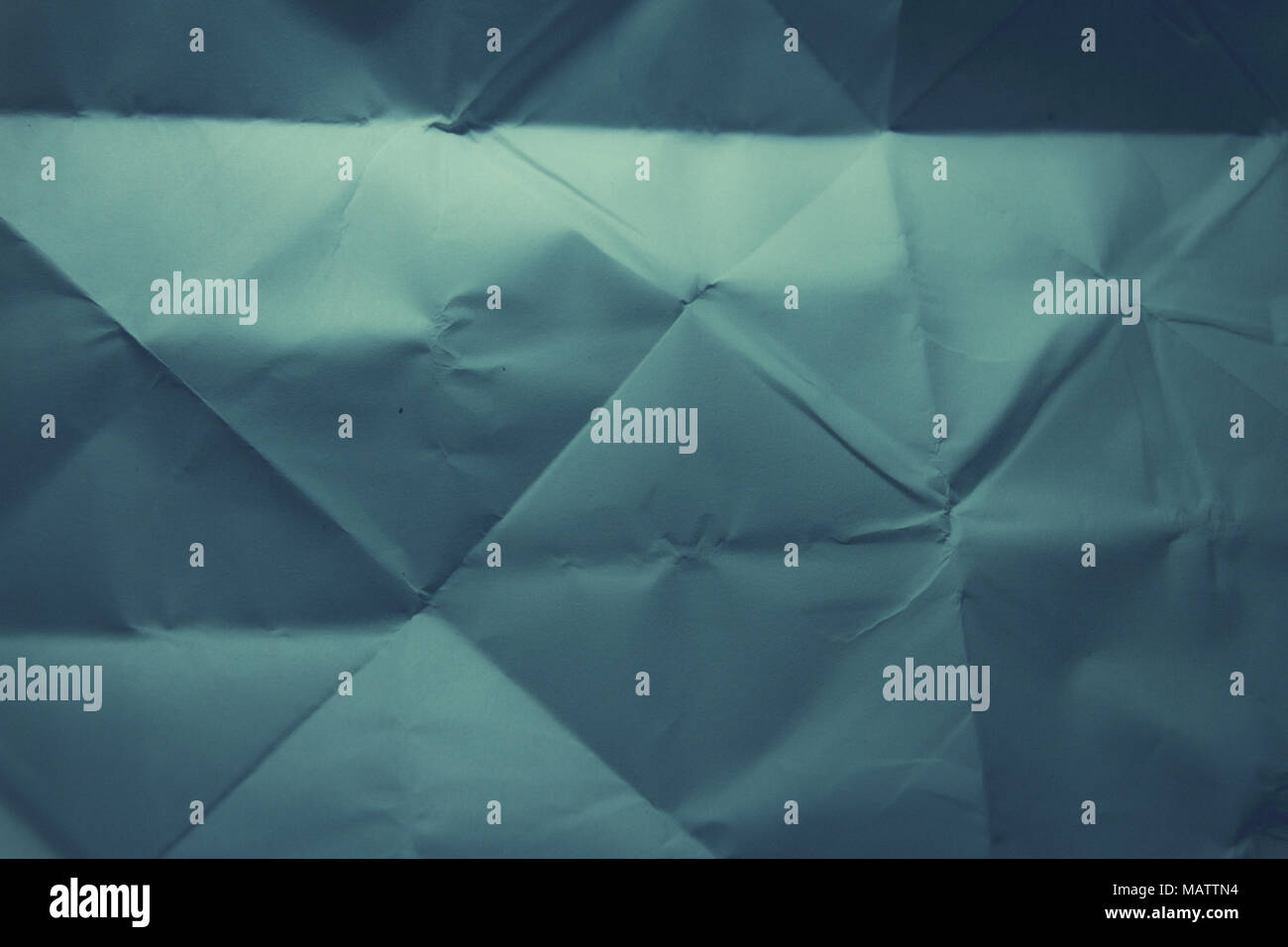Photograph of a folded paper background or texture Stock Photo - Alamy