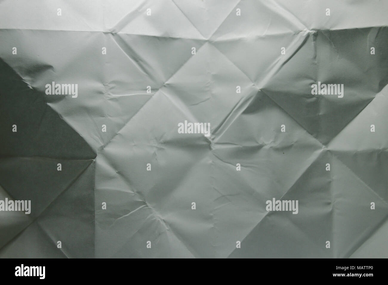 Photograph of a folded paper background or texture Stock Photo - Alamy