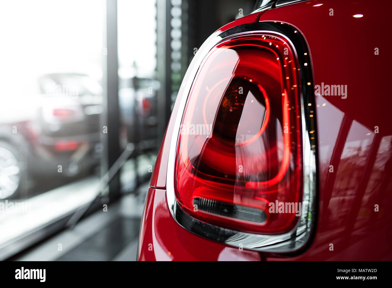 Modern back of red sport car mini cooper s with reflection on left side ...